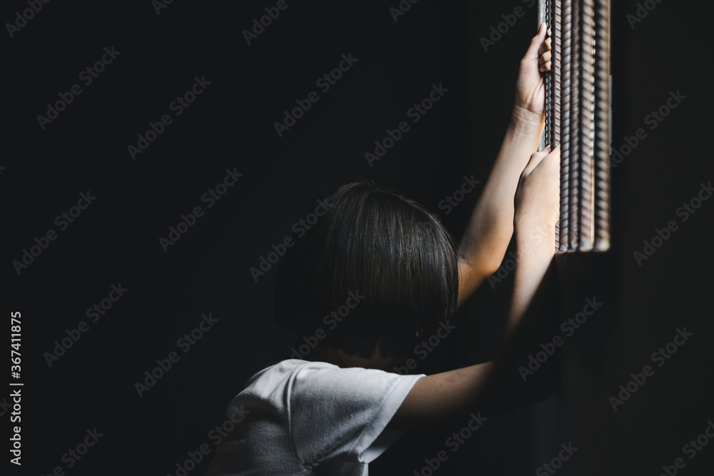 sad child holding a steel cage in old iron bar. children prison and ...