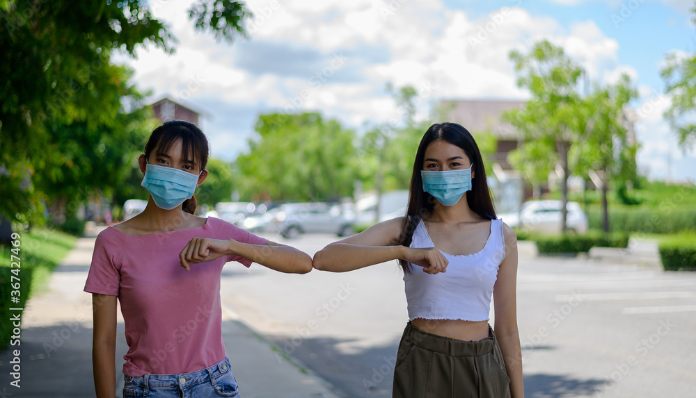 Smiling young healthy mixed race female colleagues wearing facial ...