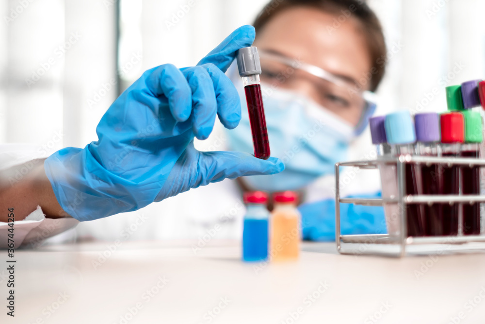 Professional doctors perform find virus tests from samples of blood ...