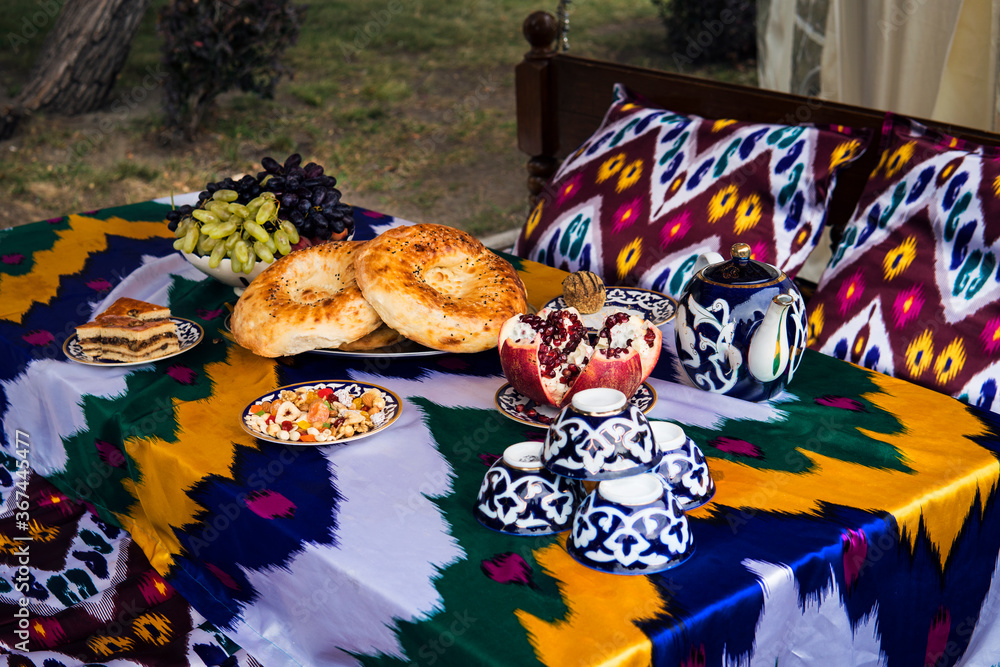 Traditional Uzbek bread on table with mugs and kettle. Cuisine of ...