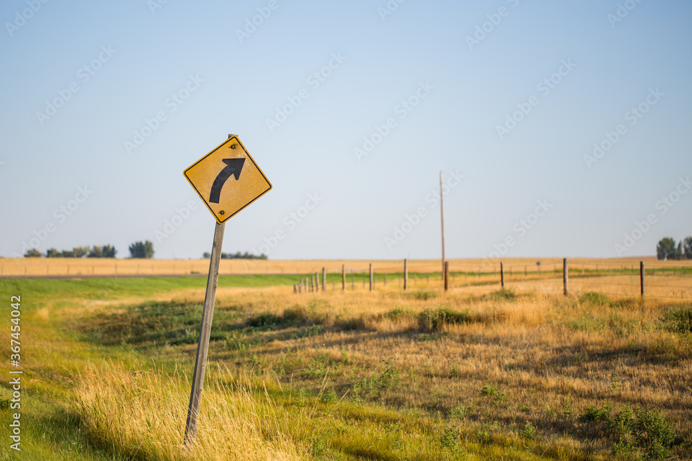 Traffic Signs Right Curve Road Warning in front of bright green and ...