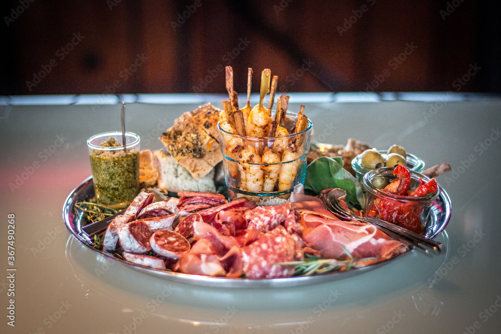 Chique platter with snacks like meat, pesto and olives Stock Photo ...