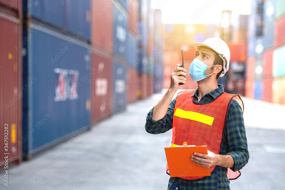 Industrial worker wear hygienic mask at logistic warehouse container ...
