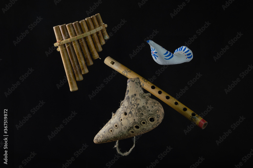 Russian folk wind instruments: two swirels and an ocarina on the black ...