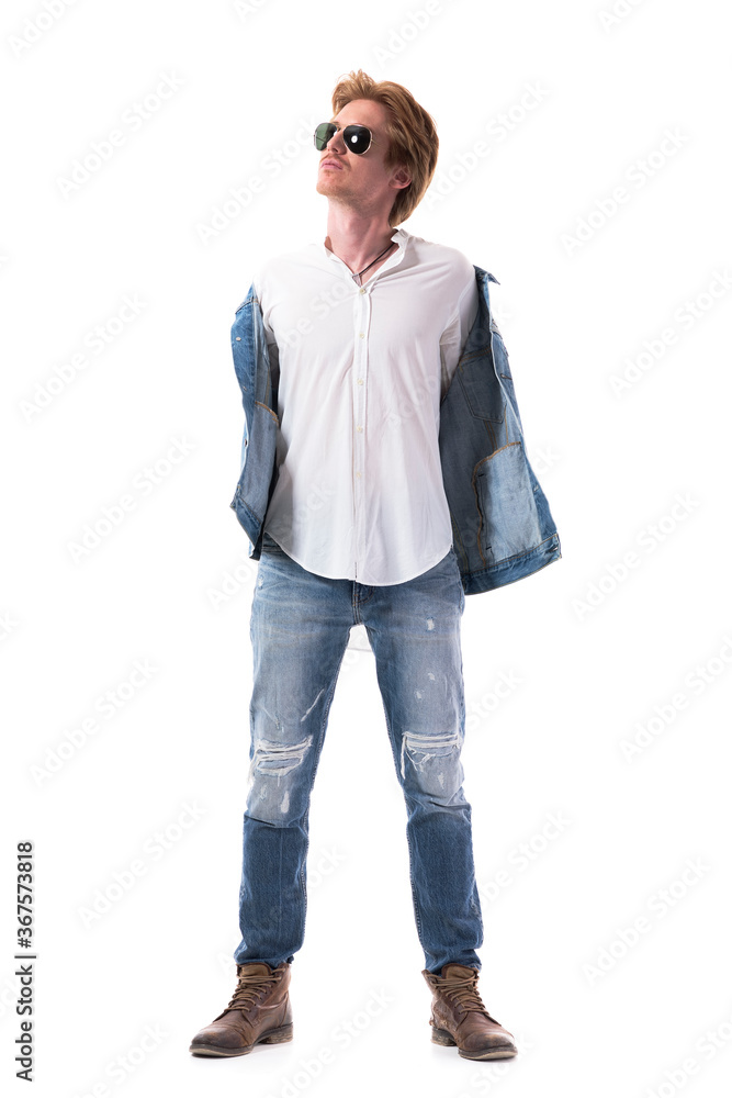 Handsome stylish young man removing jeans jacket taking off clothes ...