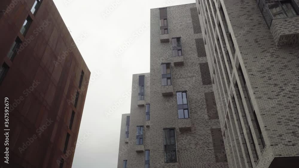 the facade of brick high-rise apartment buildings with stained glass ...