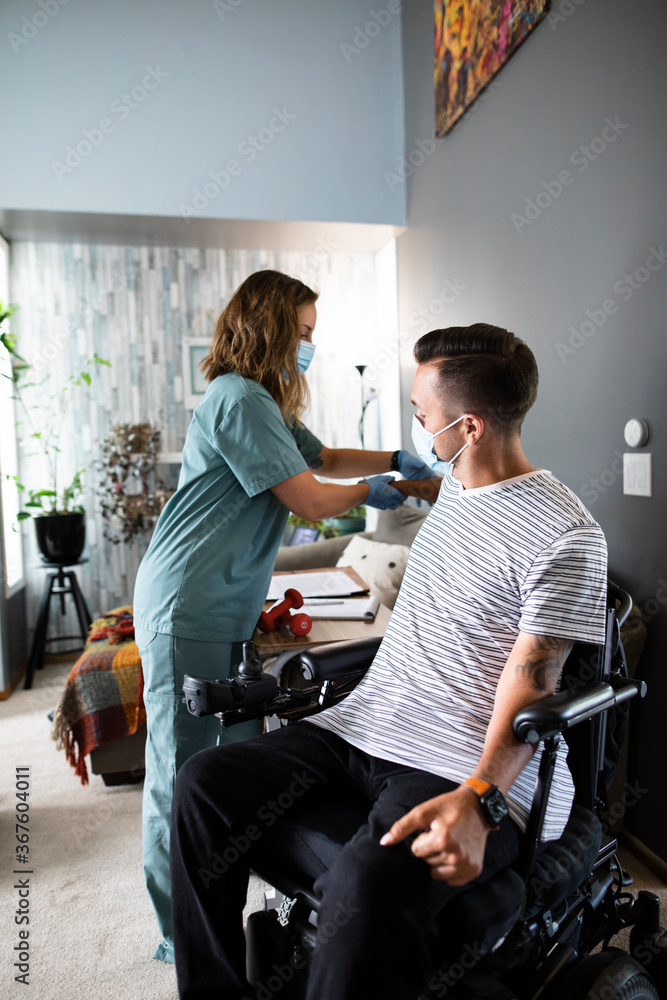 Healthcare worker helping quadriplegic man exercise arm Stock Photo ...