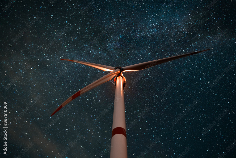 Wind turbine in the night at the stars background. Environment and ...