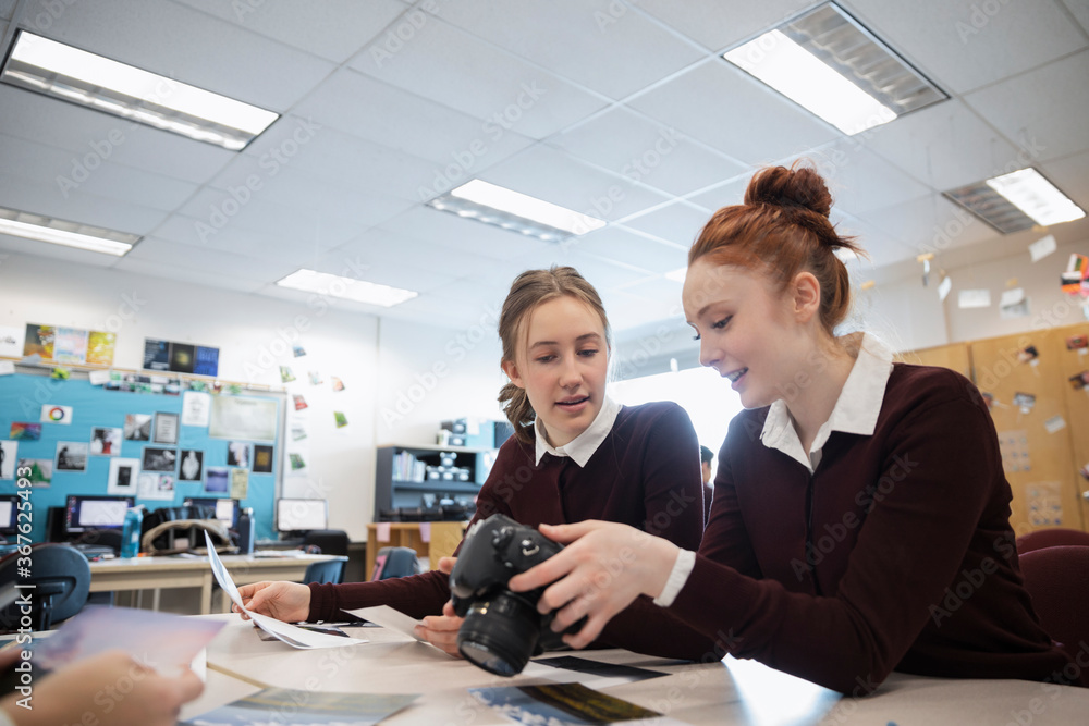 High school girl students using SLR camera in photography class Stock ...