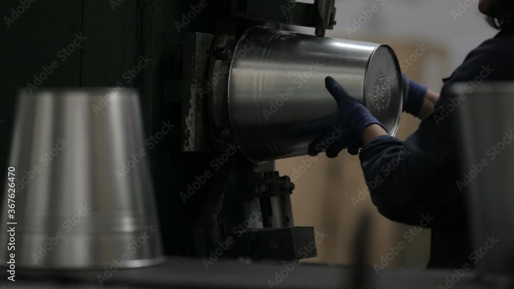 Production of aluminum buckets. Hard work at the factory. Manufacture ...