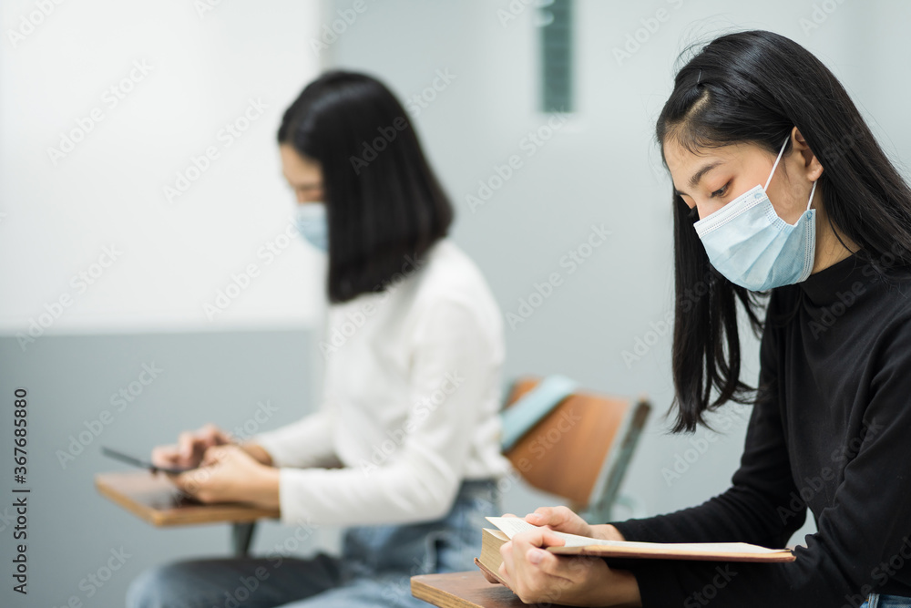 Female teenager college students wears face mask and keep distance ...