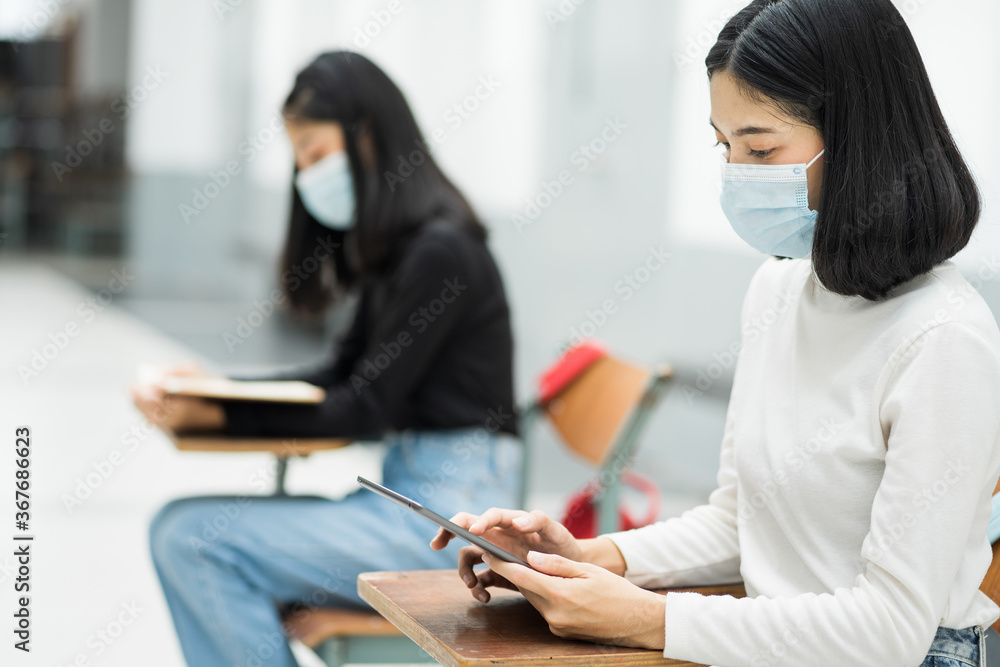 Female teenager college students wears face mask and keep distance ...