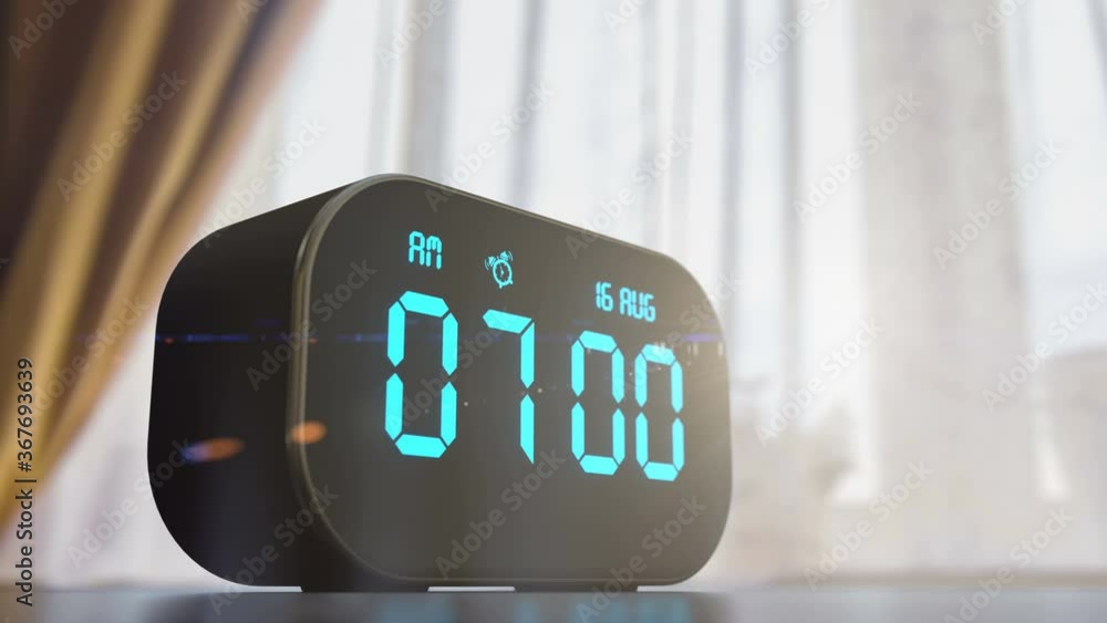 Alarm clock ringing at 7 am in the bedroom on a background of the ...
