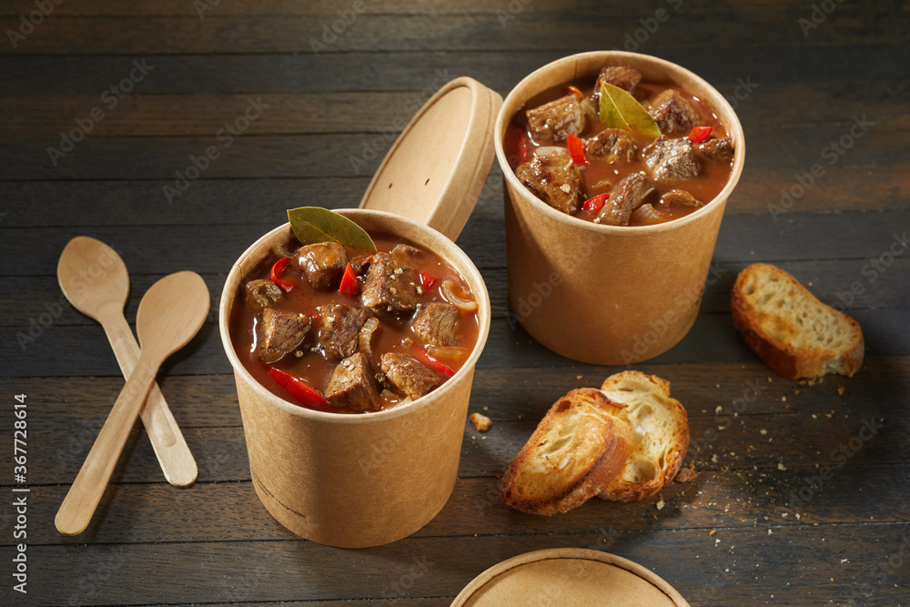 Two unlabelled takeaway tubs of rich beef goulash Stock Photo | Adobe Stock