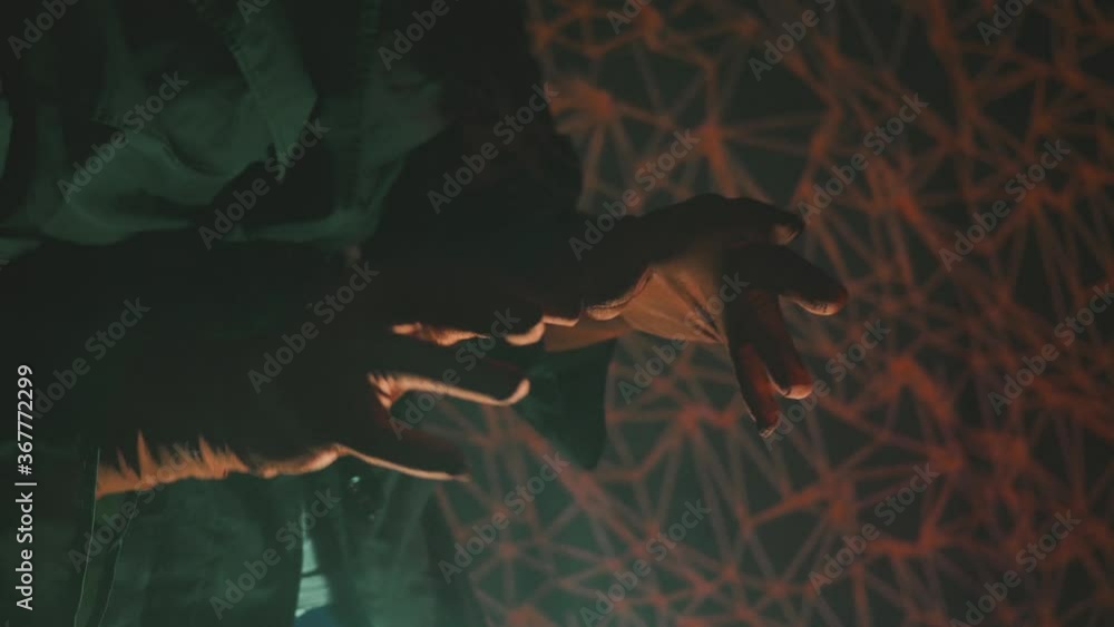 Scarry scene where a villain wearing red gloves is trying to summon the ...