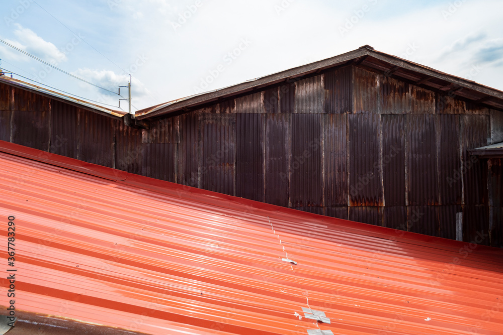roof of old and rusty galvanized sheet and new red metal roof. Stock ...