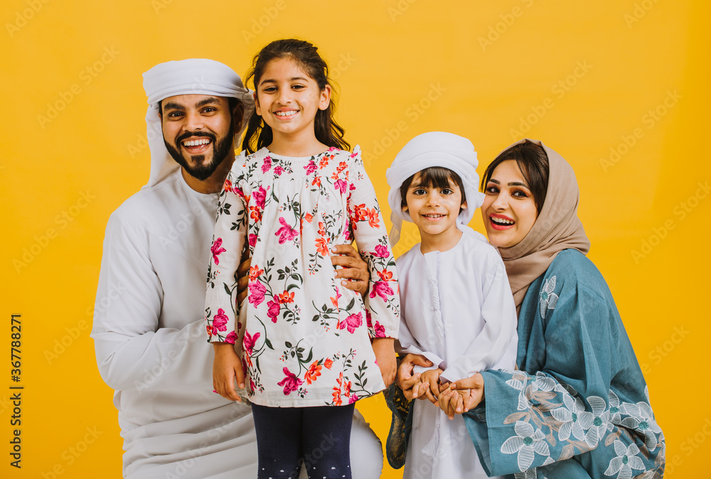 Happy family in Dubai. parents and children with traditional emirati ...