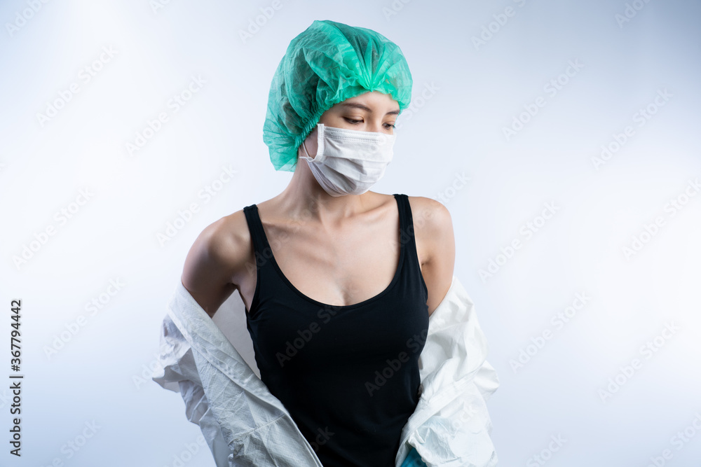 Female doctor in PPE (personal protective equipment), take off hazmat ...