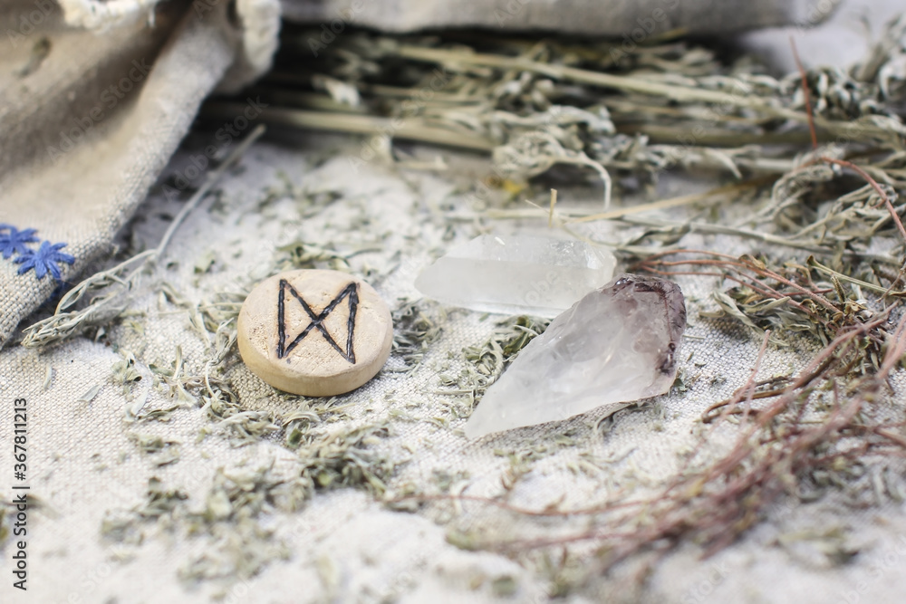 Scandinavian wooden rune Dagaz, Daeg on a rough linen cloth with ...