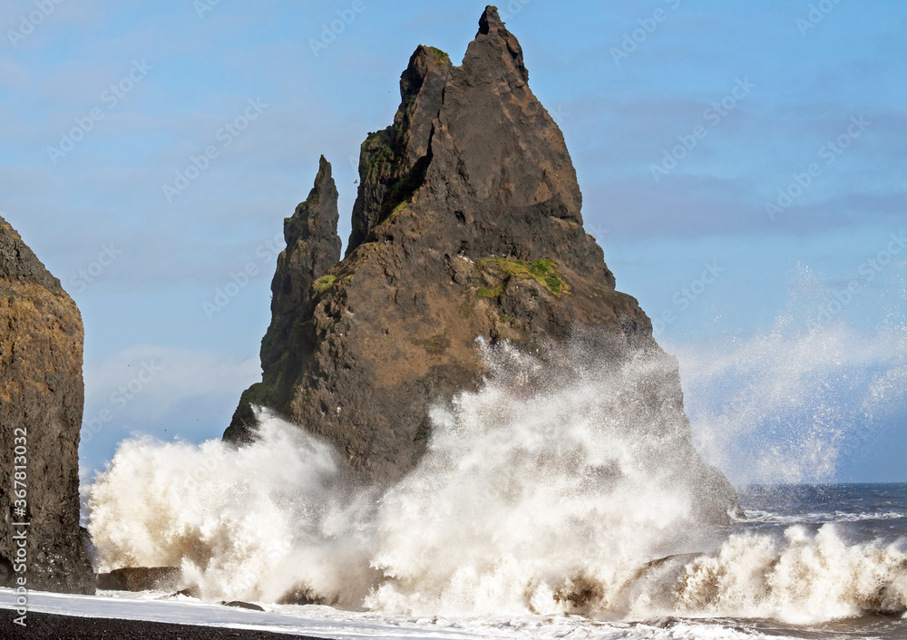Black basalt sea stacks of Reynisdrangur at Reynisfjara beach, near Vik ...