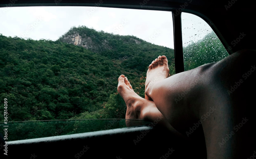 Girl sticking her feet out the window Stock Photo | Adobe Stock