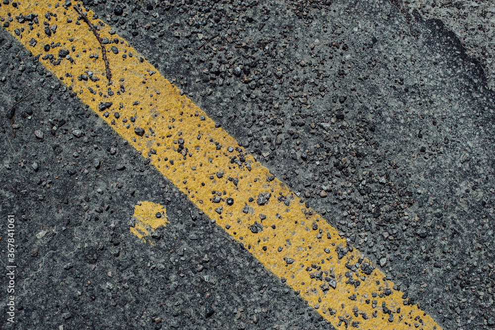 Texture of asphalt and yellow road markings, line and dot, close up ...