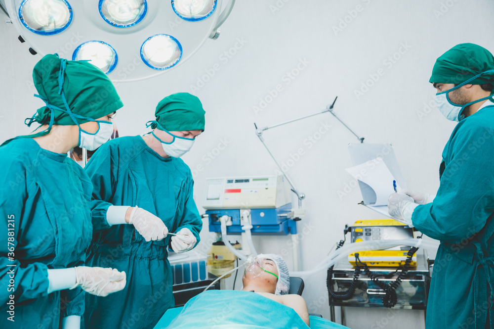 Medical team of surgeons in hospital doing invasive surgical ...