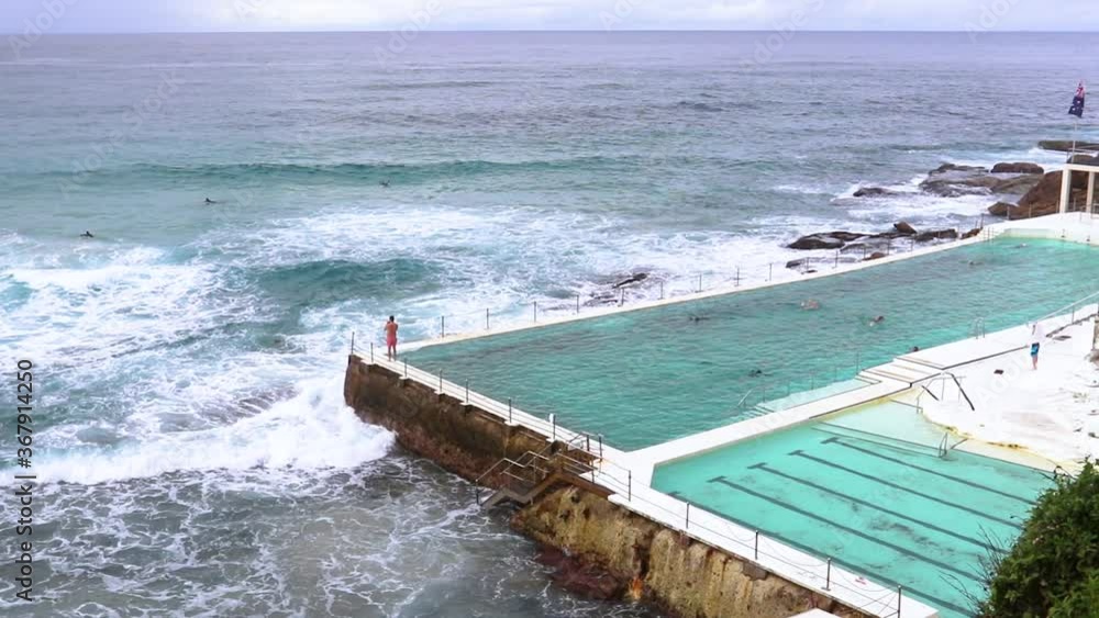 Ocean Surf Waves Crashing On Blue Swimming Pool With People At Bondi ...