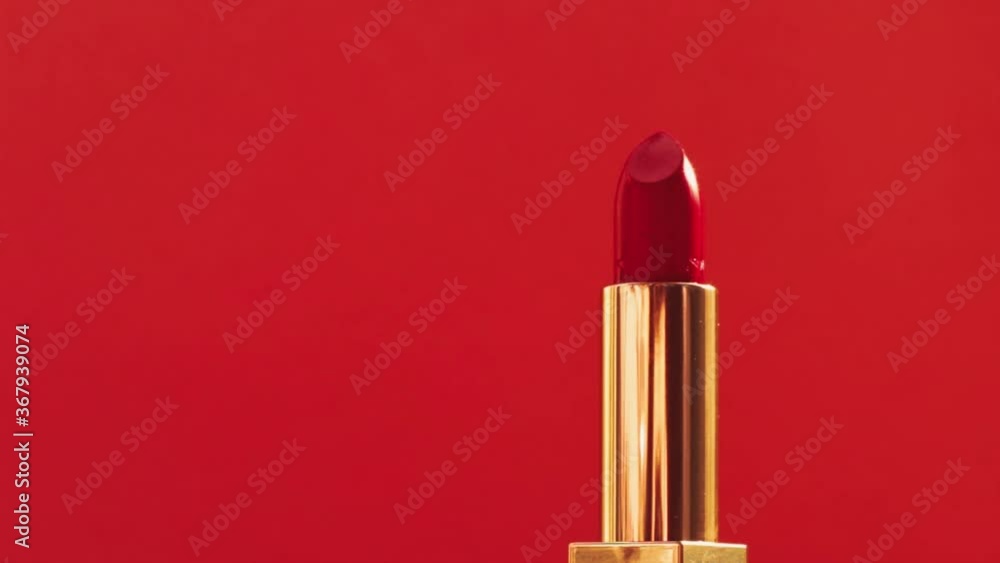 Red lipstick in golden tube and shining light flares, luxury make-up ...
