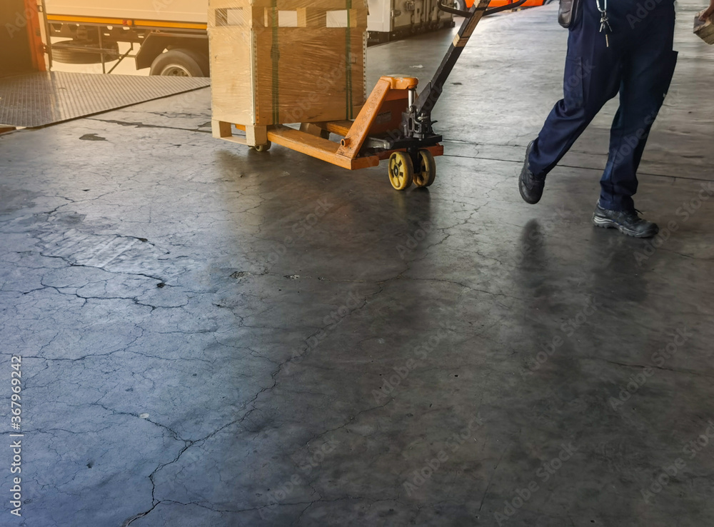 Worker driving forklift loading and unloading shipment carton boxes and ...