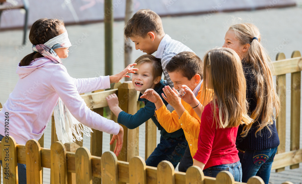 Happy children playing at Blind man bluff outdoors Stock Photo | Adobe ...