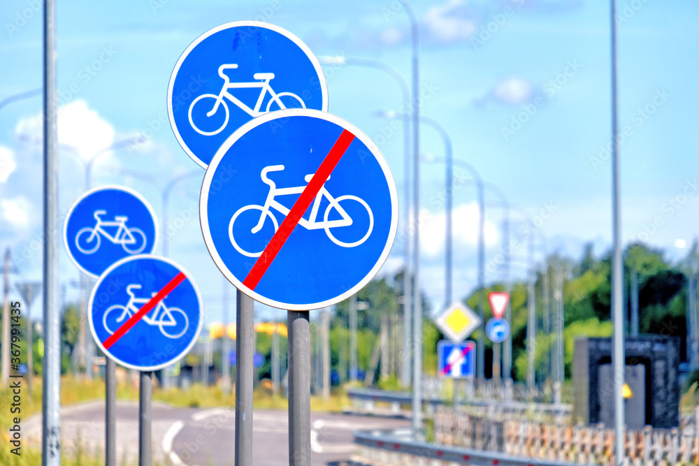 road sign for bike traffic lane on modern street in city against blue ...
