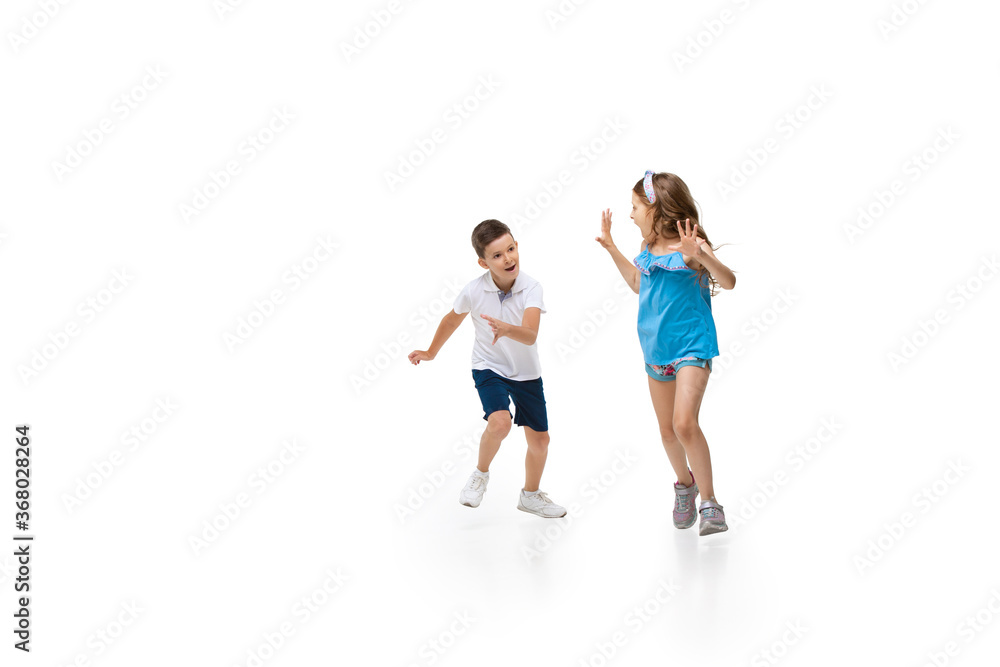 Happy kids, little and emotional caucasian boy and girl jumping and ...