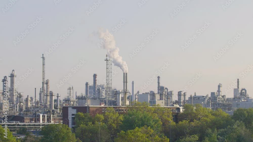Steam comes out of a chimney at a large factory Stock Video | Adobe Stock