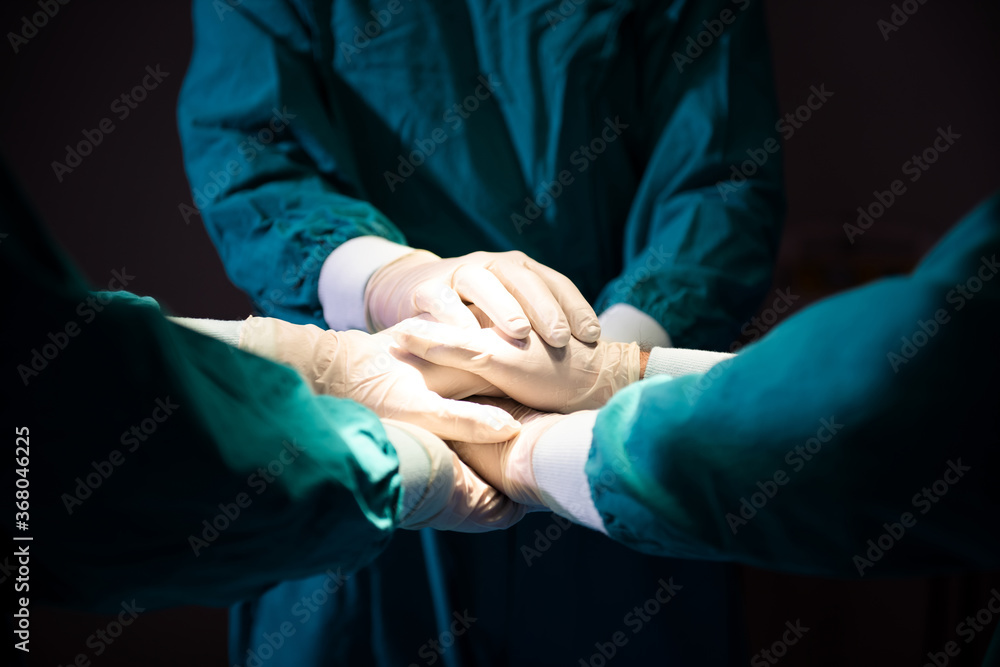 Group Surgeon doctor joining hands before Patient surgery in hospital ...