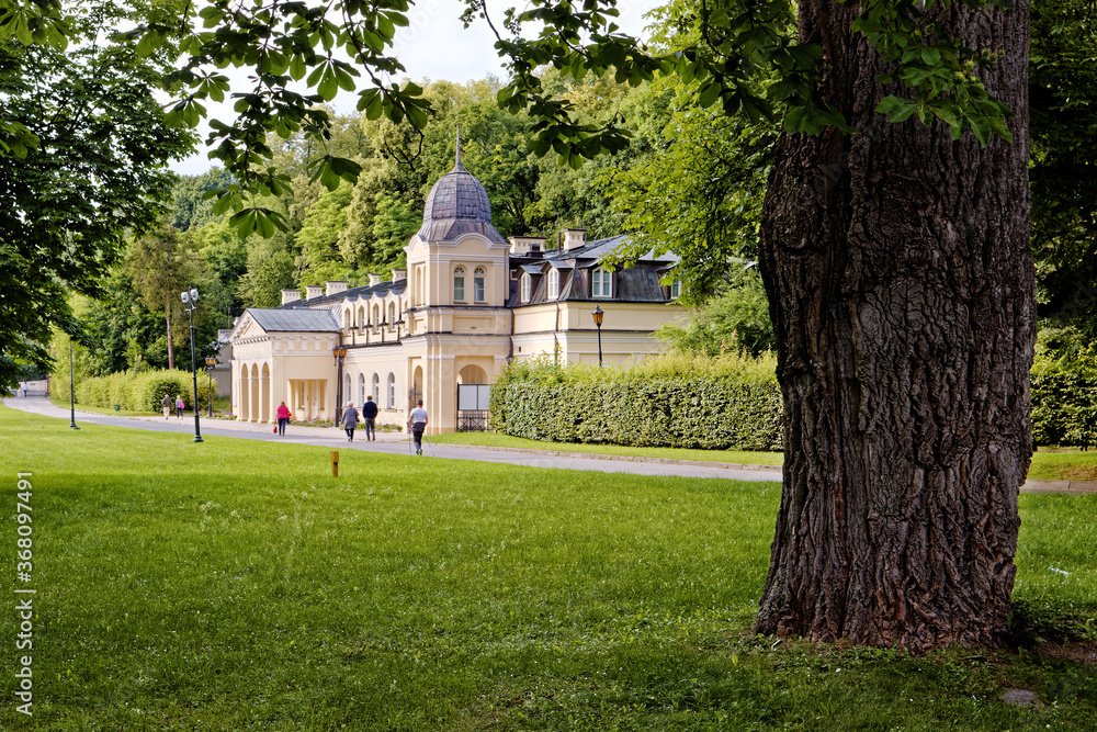 Sunny day in park in Naleczow health resort in Poland. Neoclassical ...