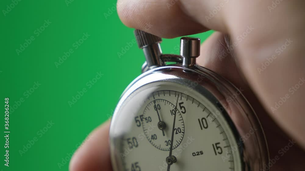 Male hand holding analogue stopwatch on green screen chroma key. Time ...