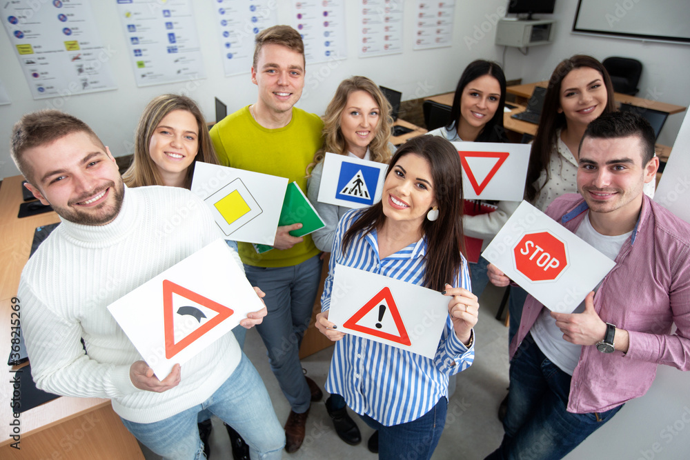 Students holding paper images of road traffic signs Stock Photo | Adobe ...