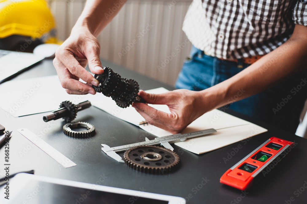 The engineer worked on a desk to design a simulation of the gears ...