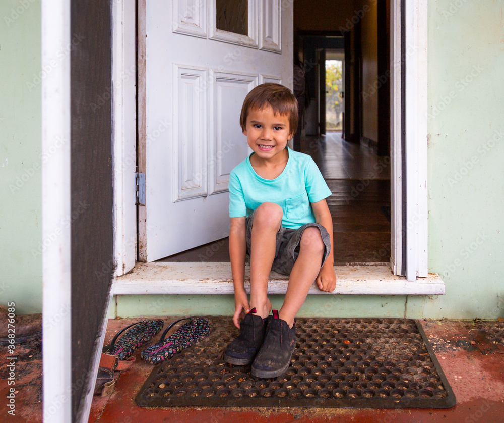 Boy Putting On Shoes