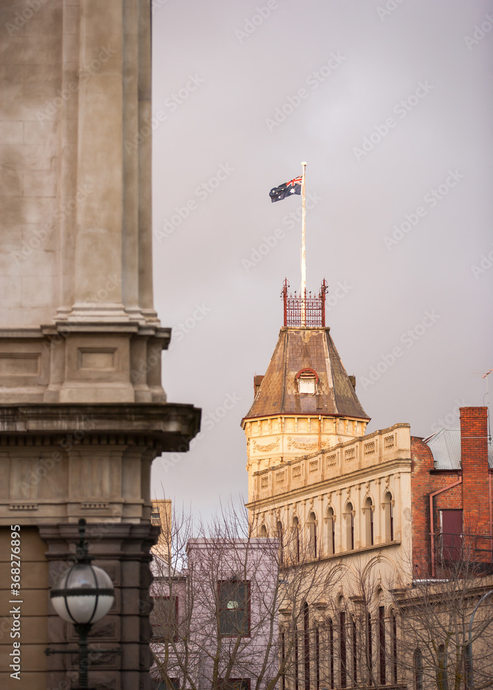 Australian flag flying above a heritage building Stock Photo | Adobe Stock