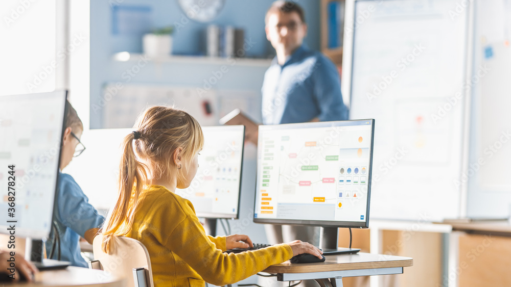 Elementary School Computer Science Classroom: Cute Little Girl Uses ...