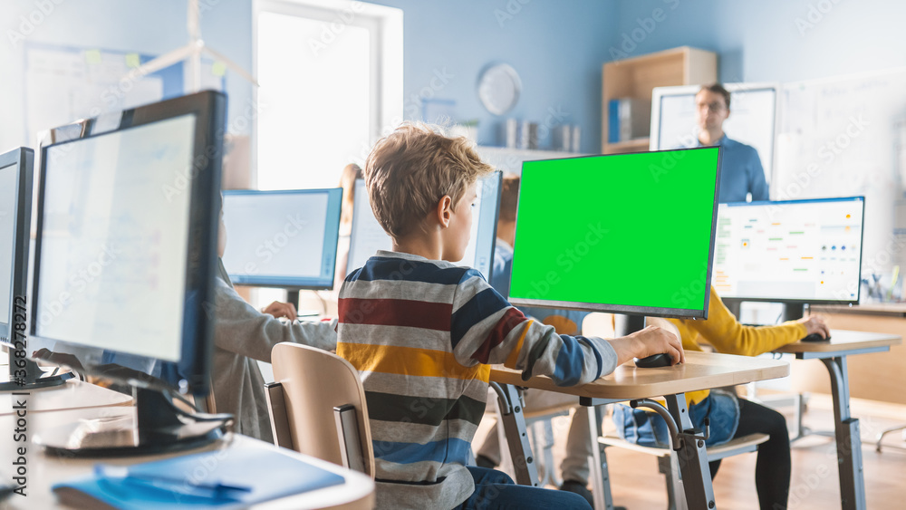 Elementary School Computer Science Classroom: Cute Little Boy Uses ...