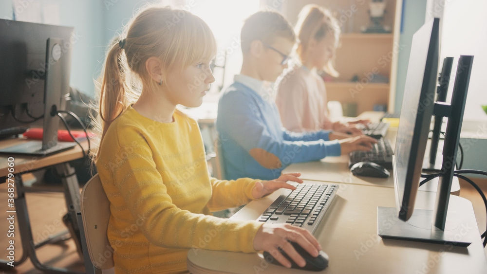 Elementary School Computer Science Classroom: Cute Little Girl Uses ...