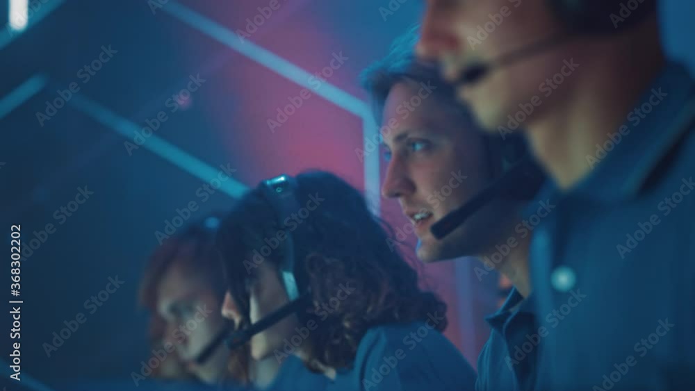 Professional Gamer Plays Computer Video Game Talking into Headset with ...