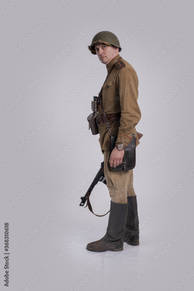 Male actor in the uniform of an officer and a helmet of the Soviet Army ...