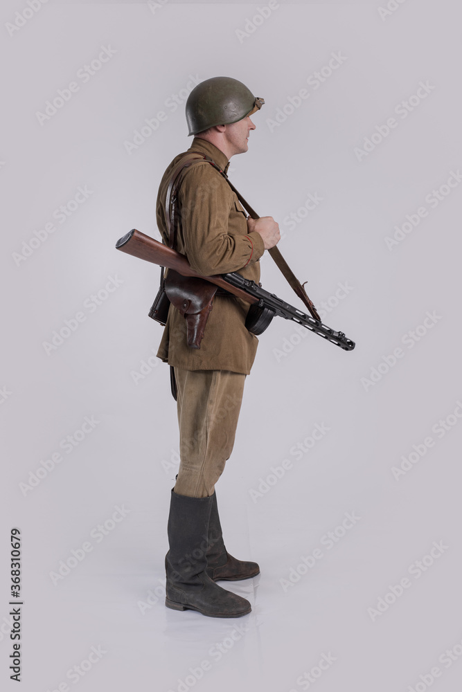 Male actor in the uniform of an officer and a helmet of the Soviet Army ...