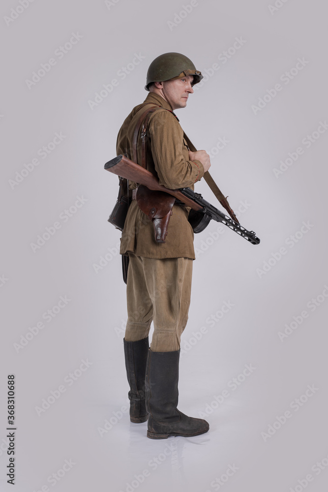 Male actor in the uniform of an officer and a helmet of the Soviet Army ...