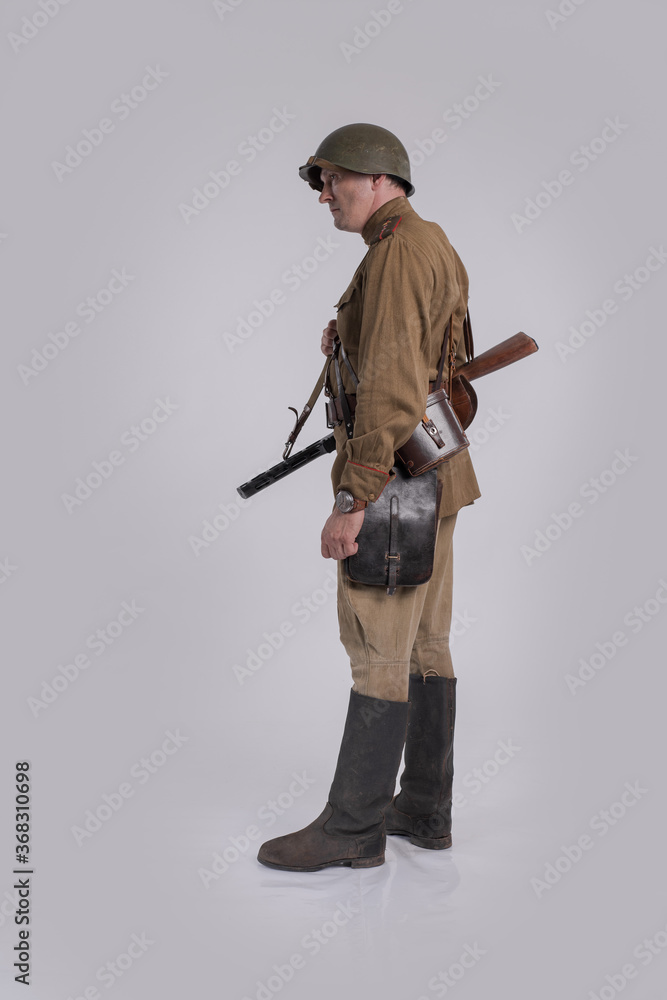 Male actor in the uniform of an officer and a helmet of the Soviet Army ...