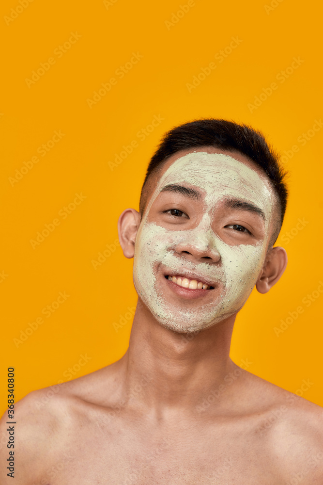 For a smooth skin. Portrait of cheerful shirtless young asian man with ...